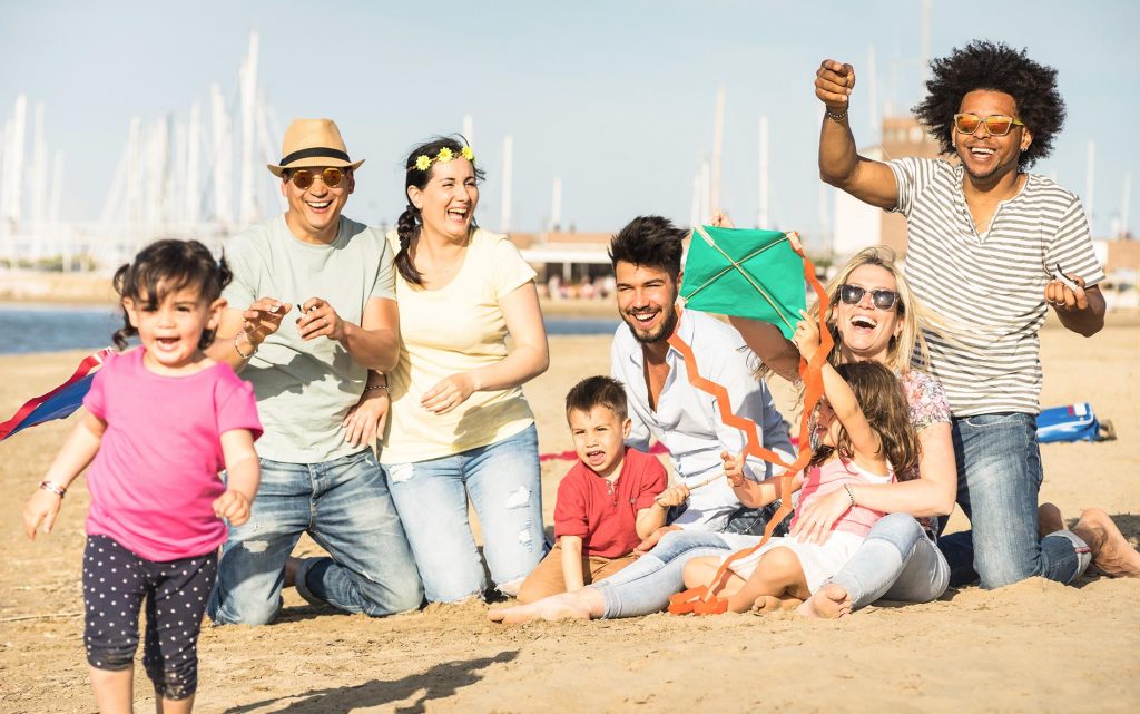 Happy multiracial families and children playing together with ki – With ...